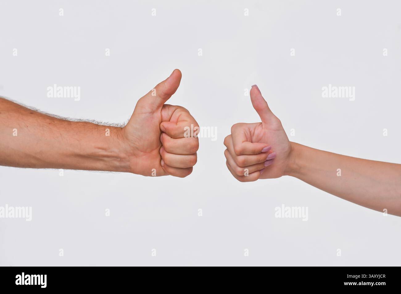 A man's and a woman's hand shows a class gesture. thumb up on a white ...