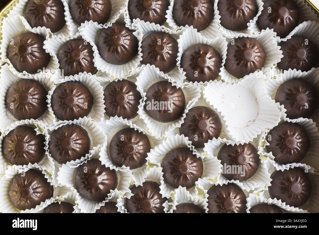 Top view and close-up of opened chocolate box with one chocolate ...