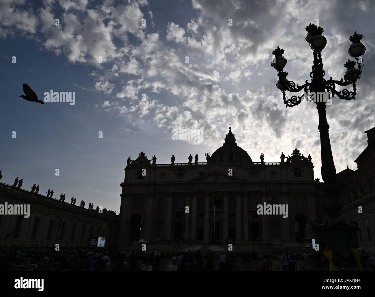 Faithful attend an evening Rosary held in St. Peter's Square, Vatican ...