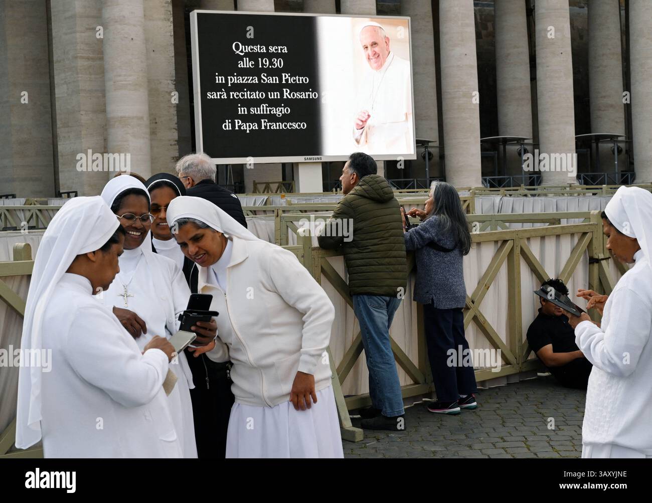 Faithful attend an evening Rosary held in St. Peter's Square, Vatican ...