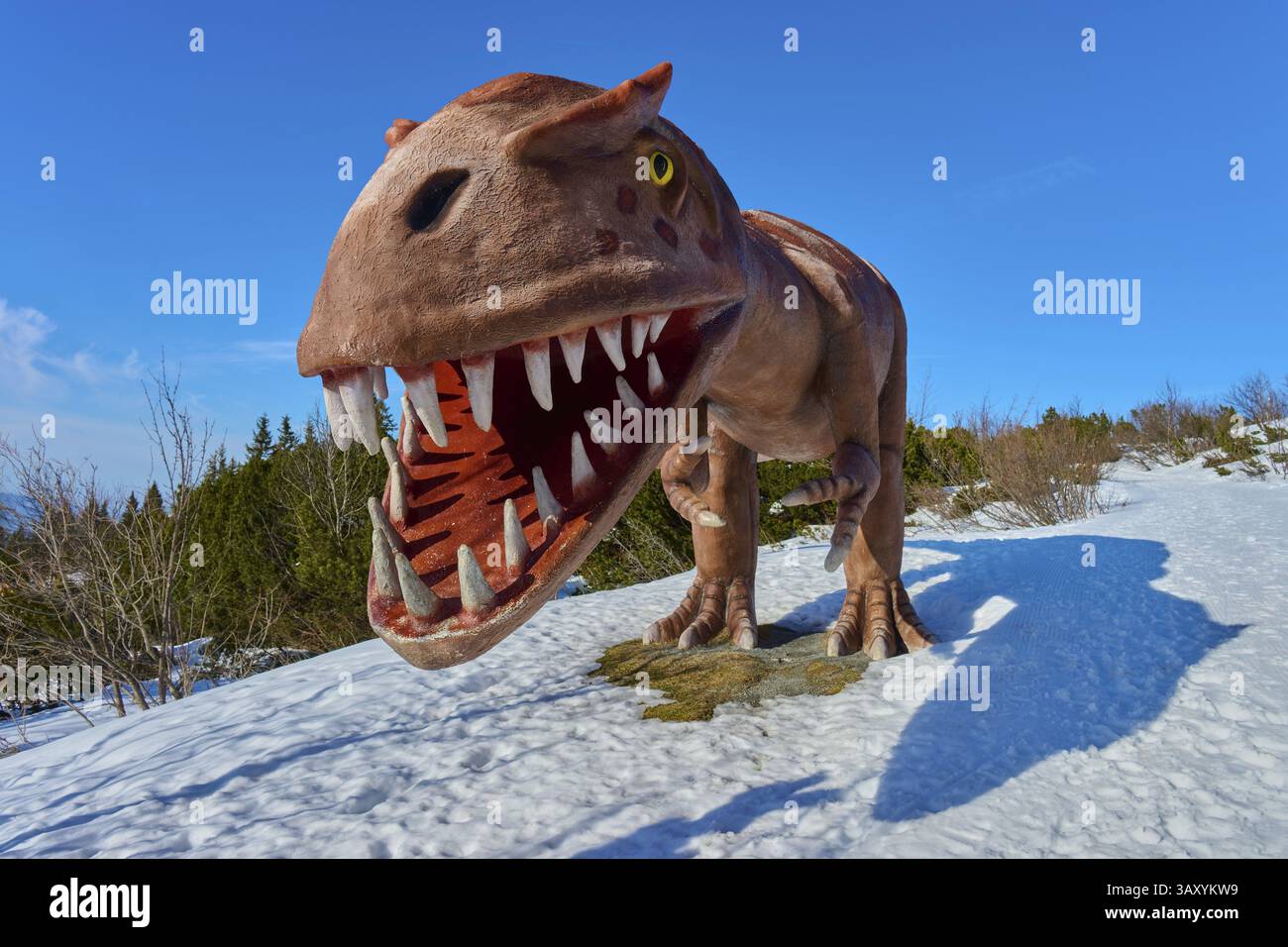 Tyrannosaurus rex, brown dinosaur sculpture with wide open mouth on ...