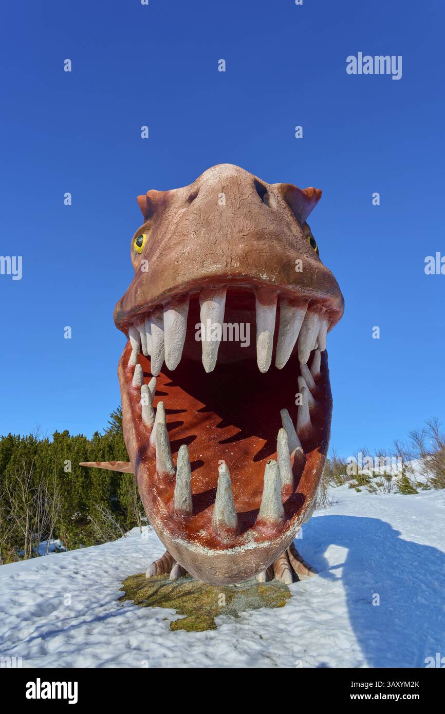 Tyrannosaurus rex, brown dinosaur sculpture with open mouth in front of ...
