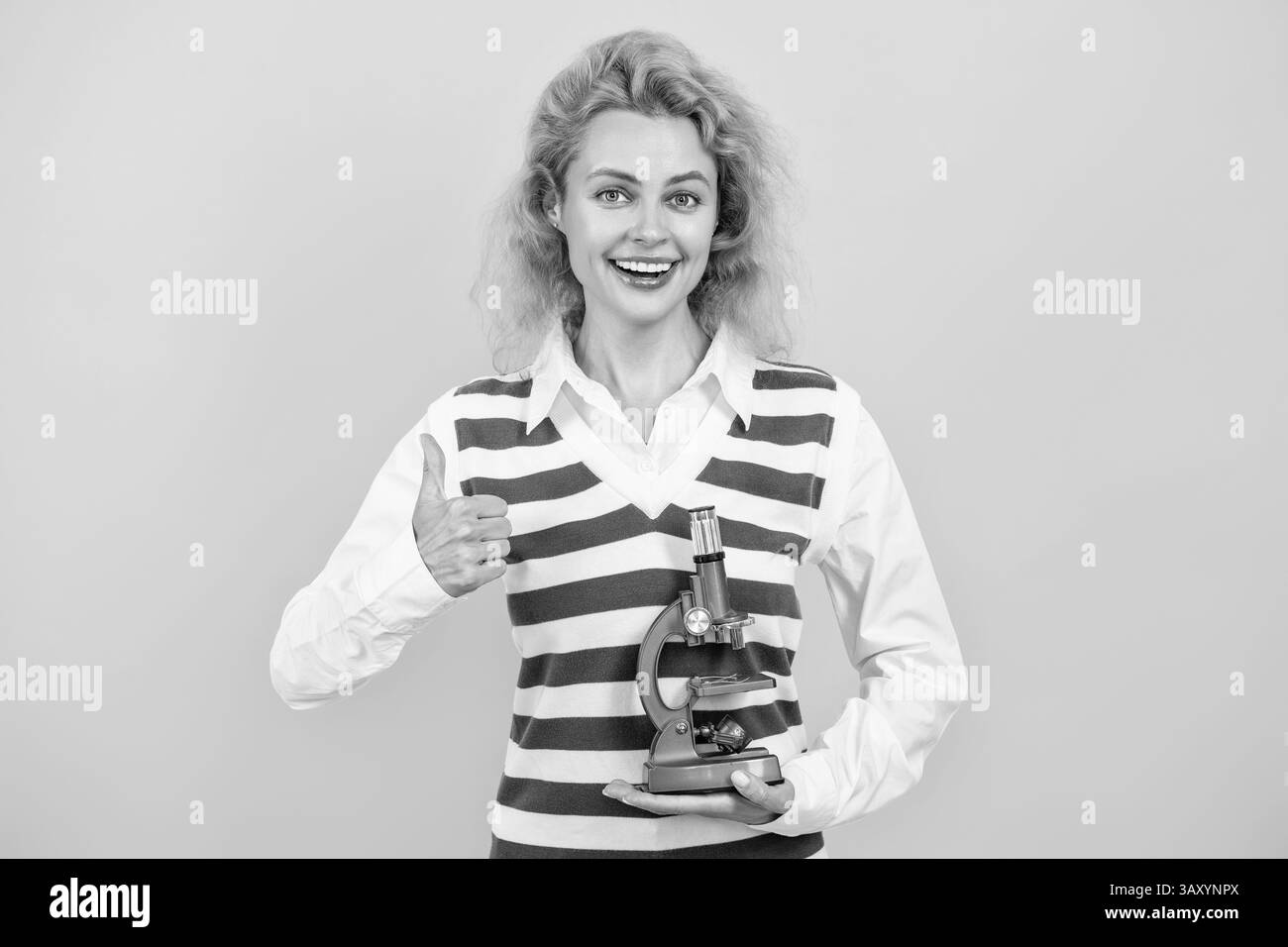 School biology teacher woman hold microscope. Woman teacher of biology ...