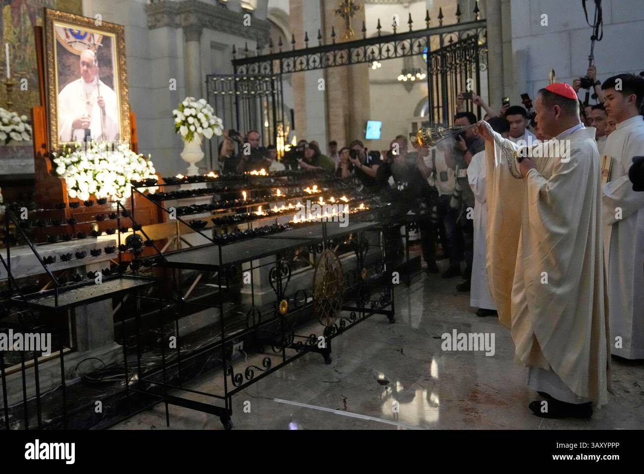 Philippine Cardinal Jose Advincula, foreground, burns incense as they ...