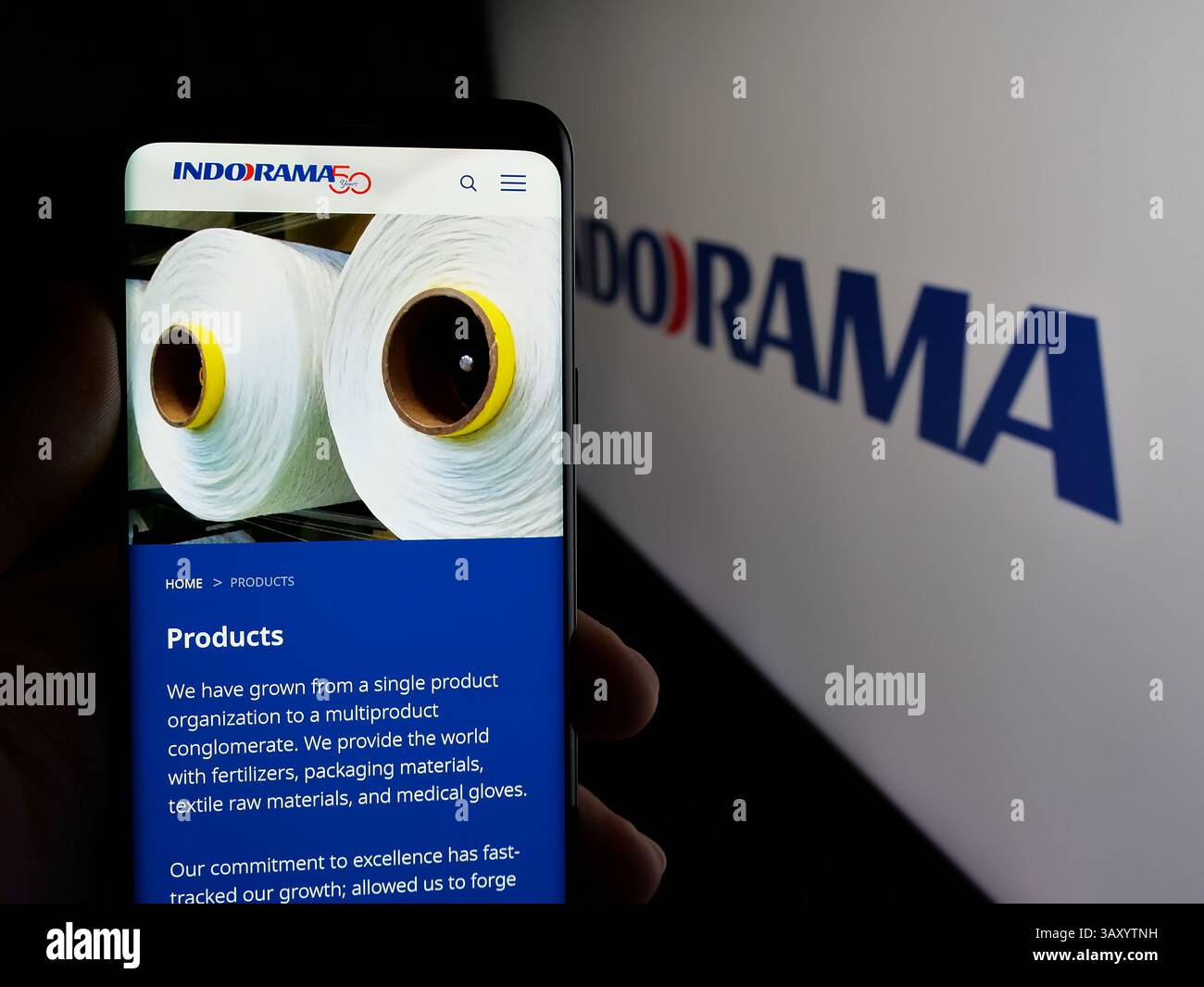 In this photo illustration, a cellphone with the webpage of textile ...