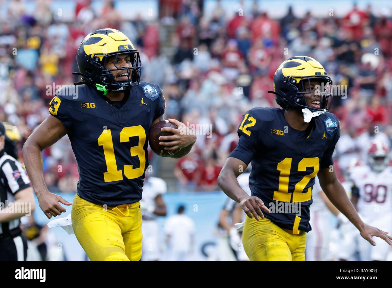 Michigan defensive back Aamir Hall (12) and Wesley Walker (13 ...