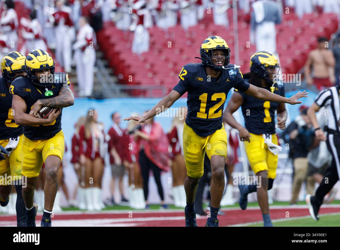 Michigan defensive back Aamir Hall (12) and Wesley Walker (13 ...