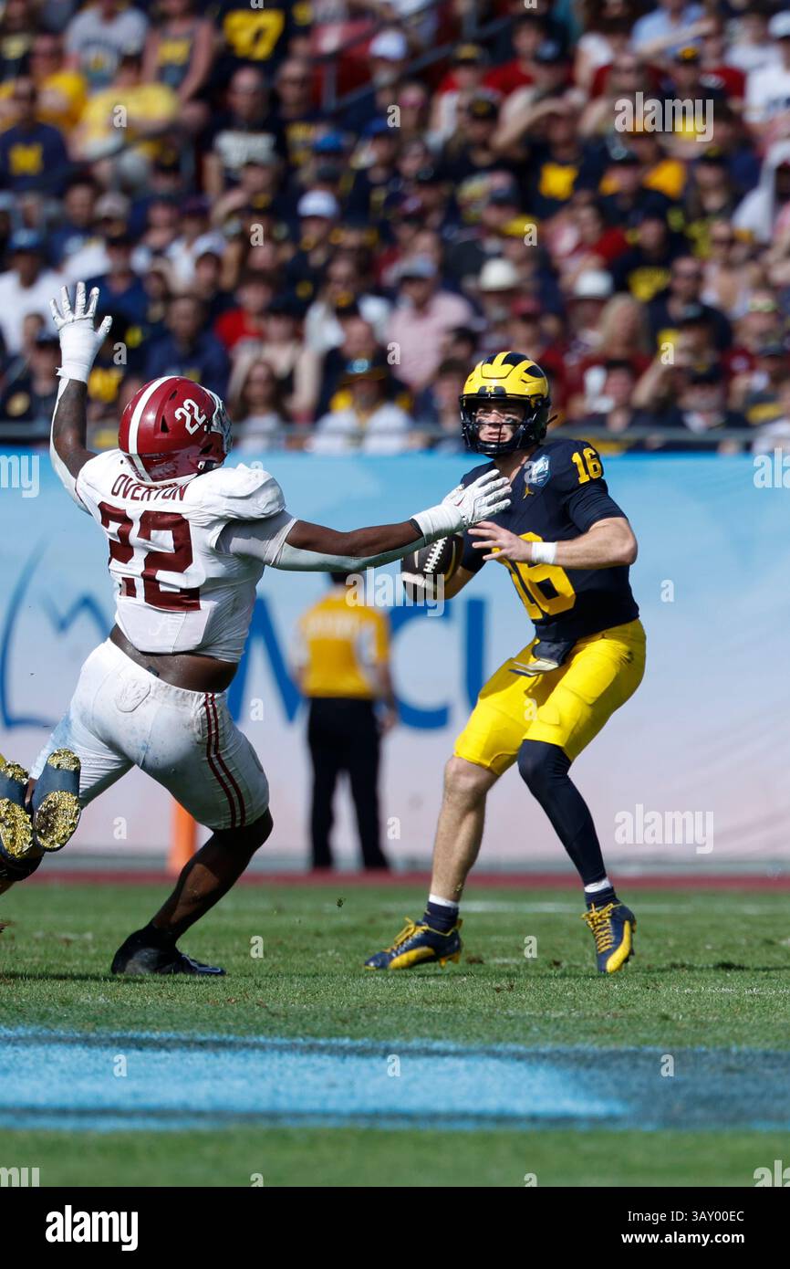Michigan quarterback Davis Warren (16) looks to pass as defensive ...