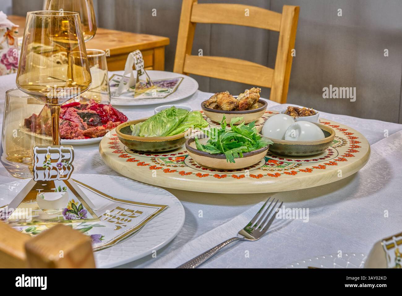 Traditional Passover seder with glassware, red fish in beet gelatin ...