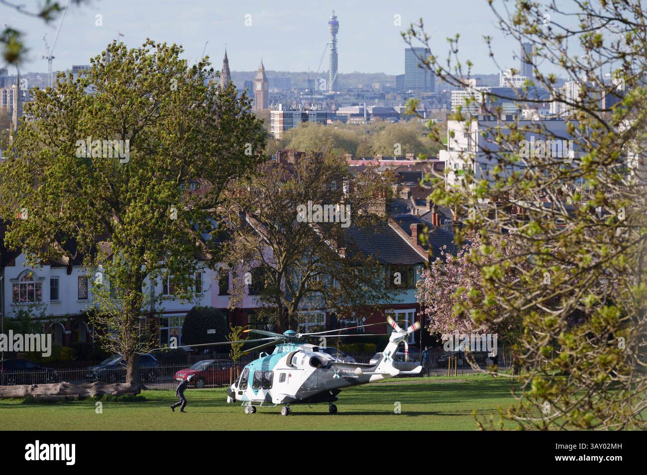 A crew member returns to his Leonardo AW169 helicopter (reg G-KSST ...