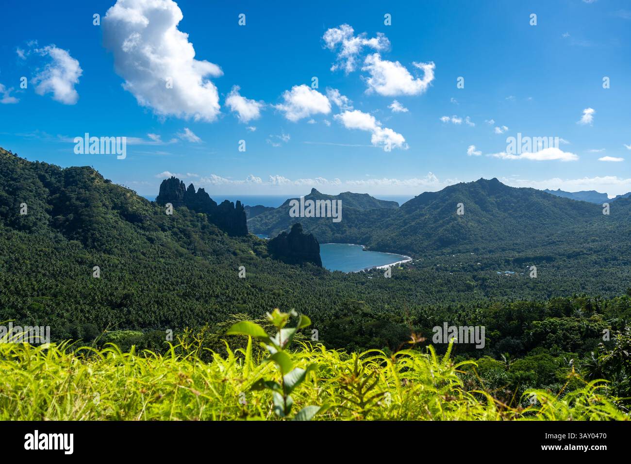 Surrounded by lush green mountains, Hatiheu Bay in Nuku Hiva features a ...