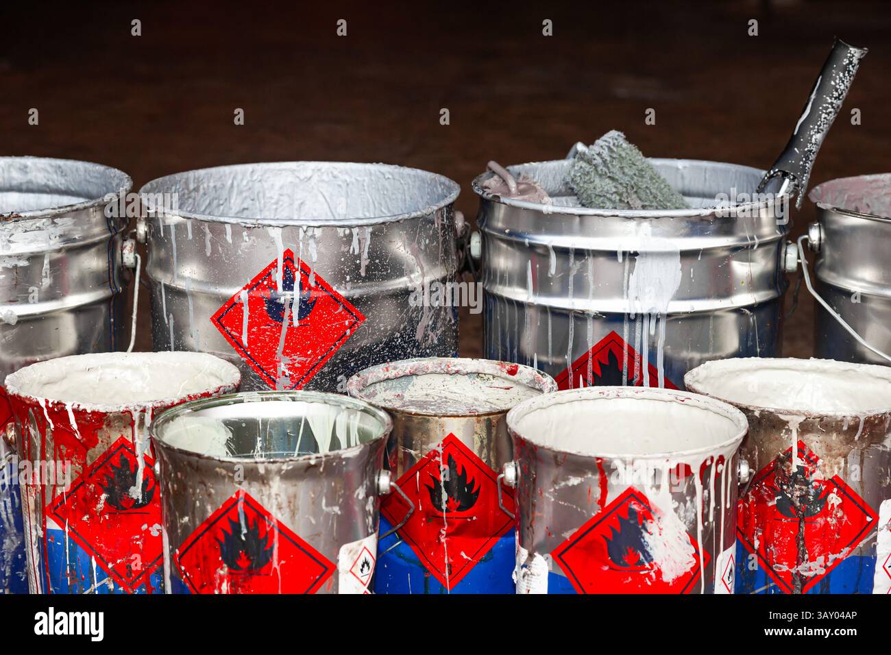 Empty paint buckets containing used rollers and brushes Stock Photo - Alamy