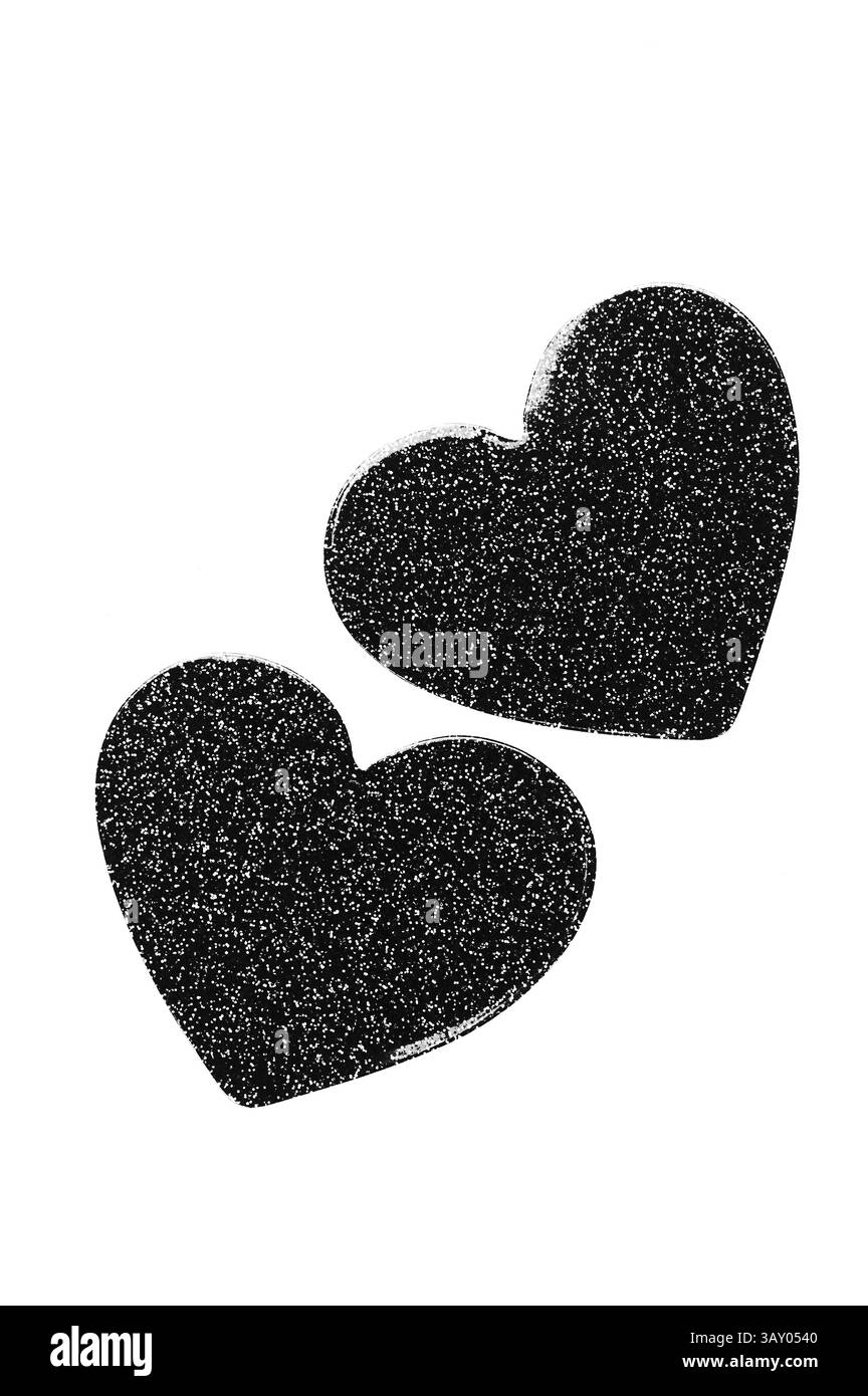 Two sparkly red heart symbols lying next to each other Stock Photo - Alamy