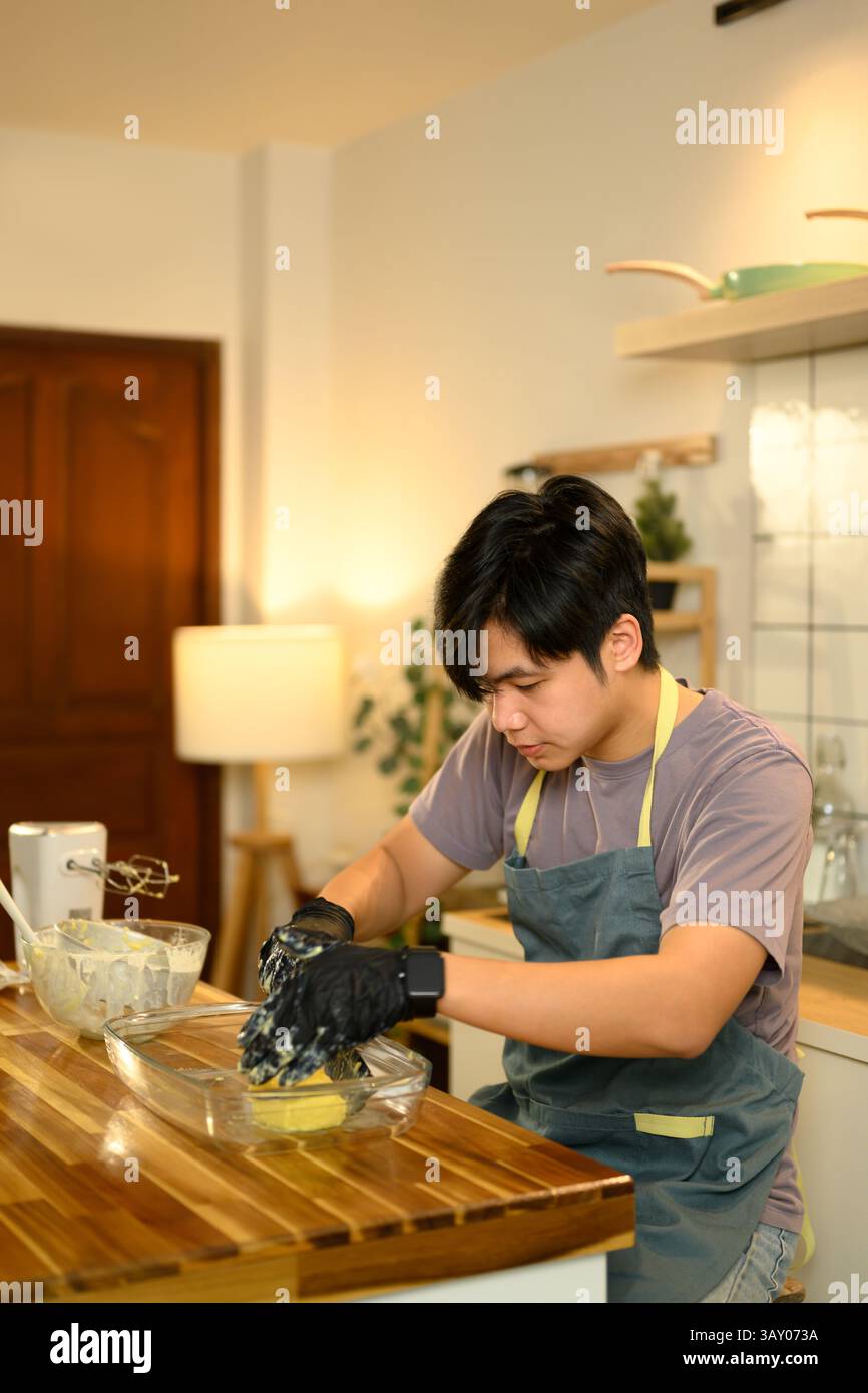 Asian man shaping compound butter by hand in a cozy kitchen Stock Photo ...