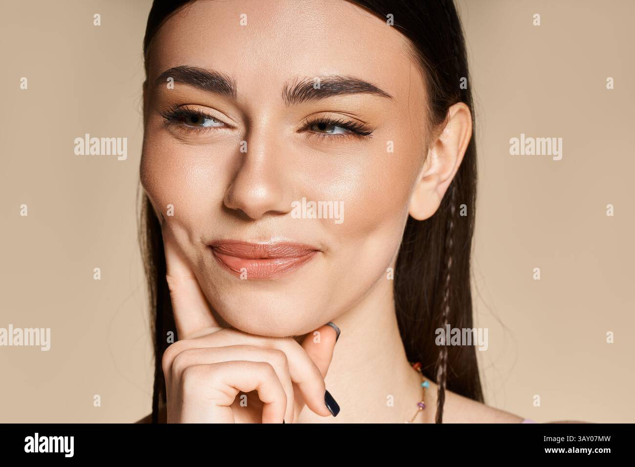 A young woman with a sun tan smiles thoughtfully, embracing summer ...