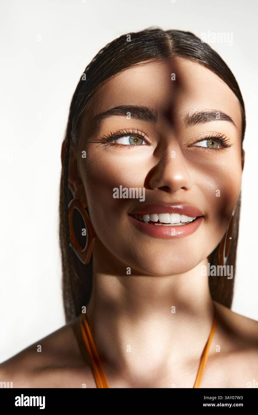 Sun-kissed young woman radiates joy while enjoying warm sunlight with ...