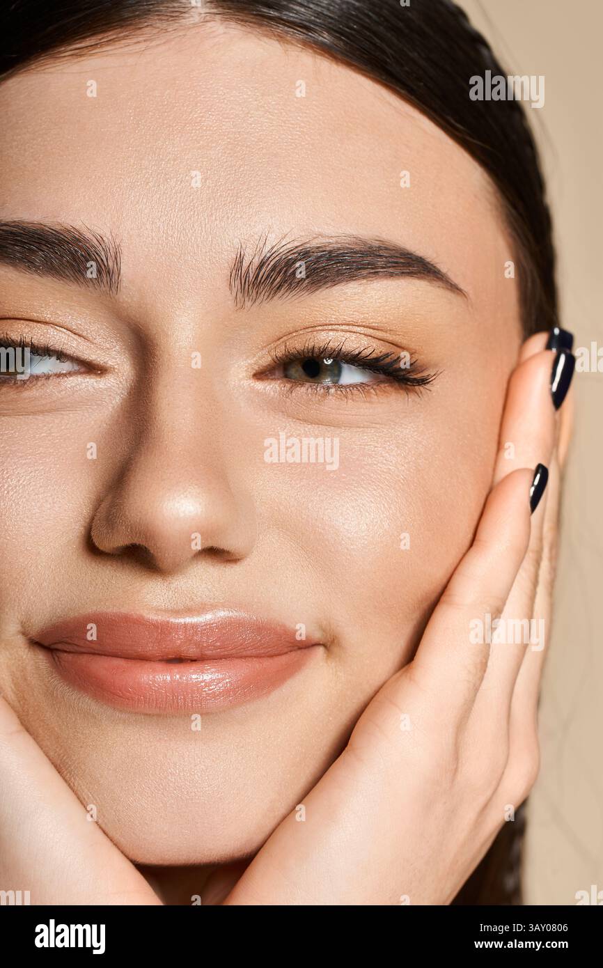 A cheerful young woman showcases her radiant sun-kissed skin while ...