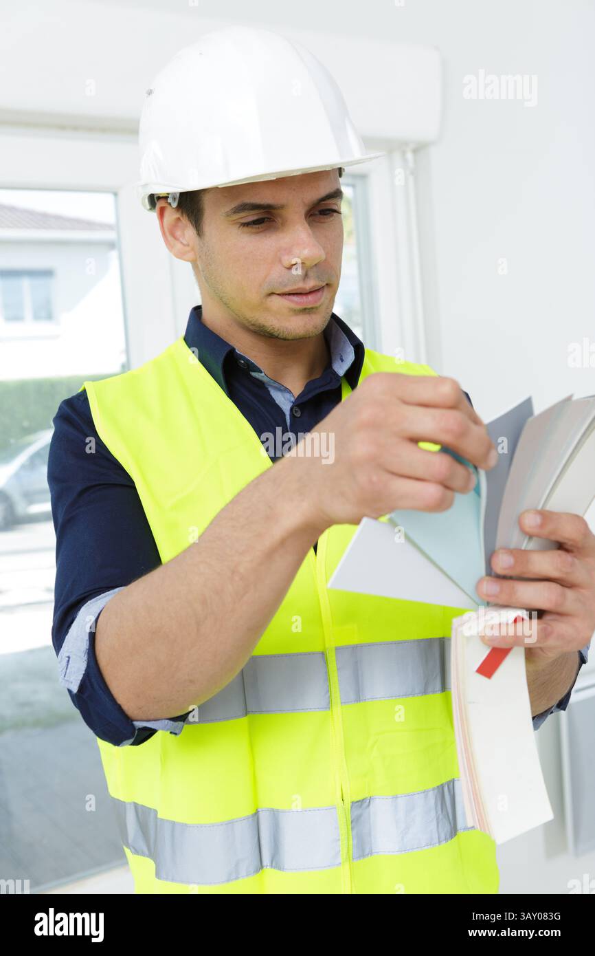 male builder with color swatches in his hand Stock Photo - Alamy