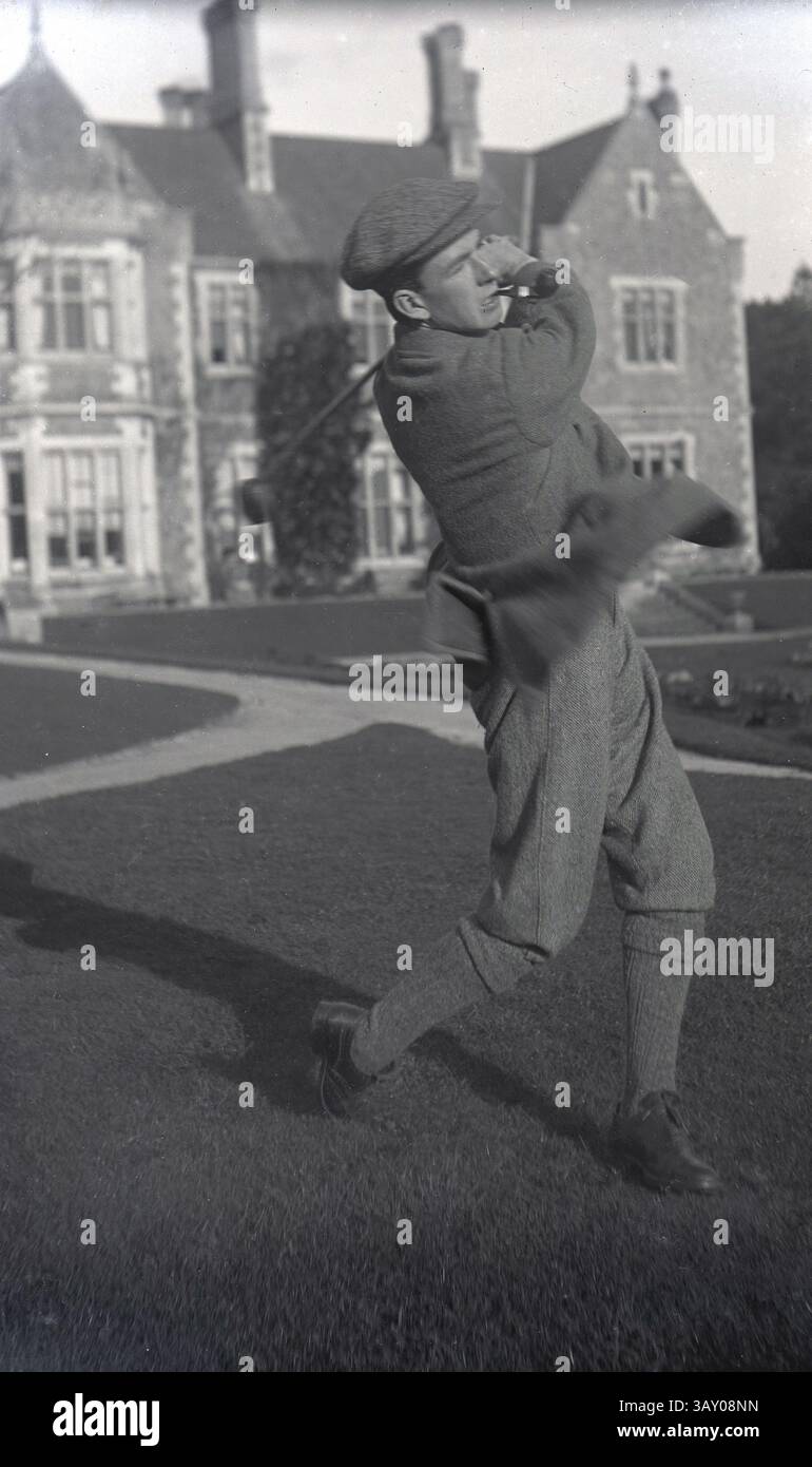 1930s, historical, outside a country house, a young male golfer in the ...
