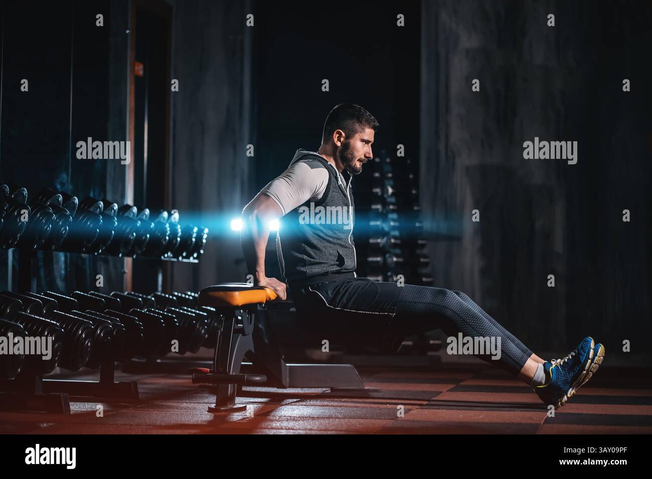 Male bodybuilder performing bench dips for triceps in gym, Man training ...