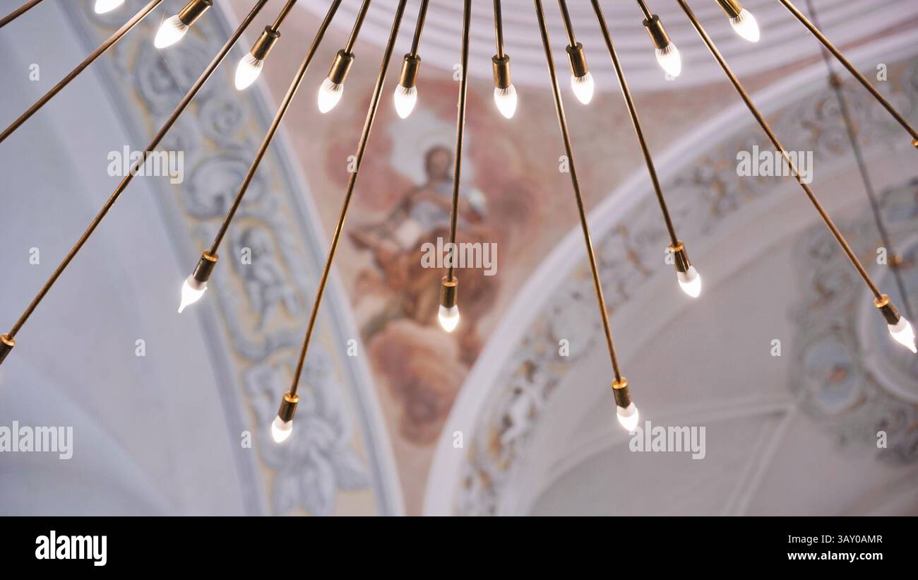 Modern chandelier illuminating ancient church ceiling Stock Photo - Alamy