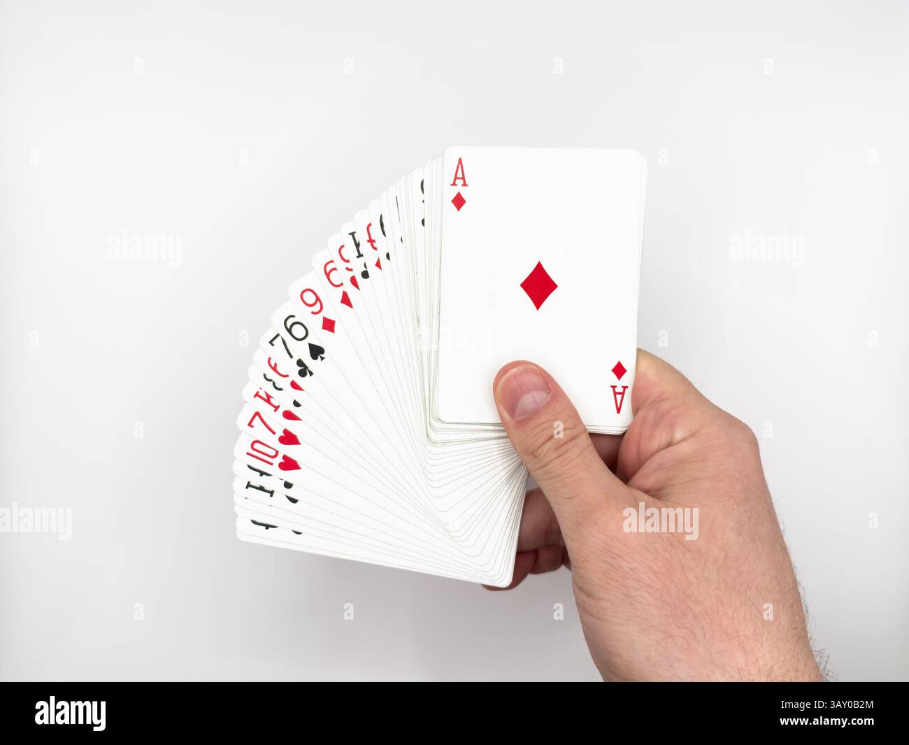 White male hand showing white plastic poker cards fan sideways centered ...