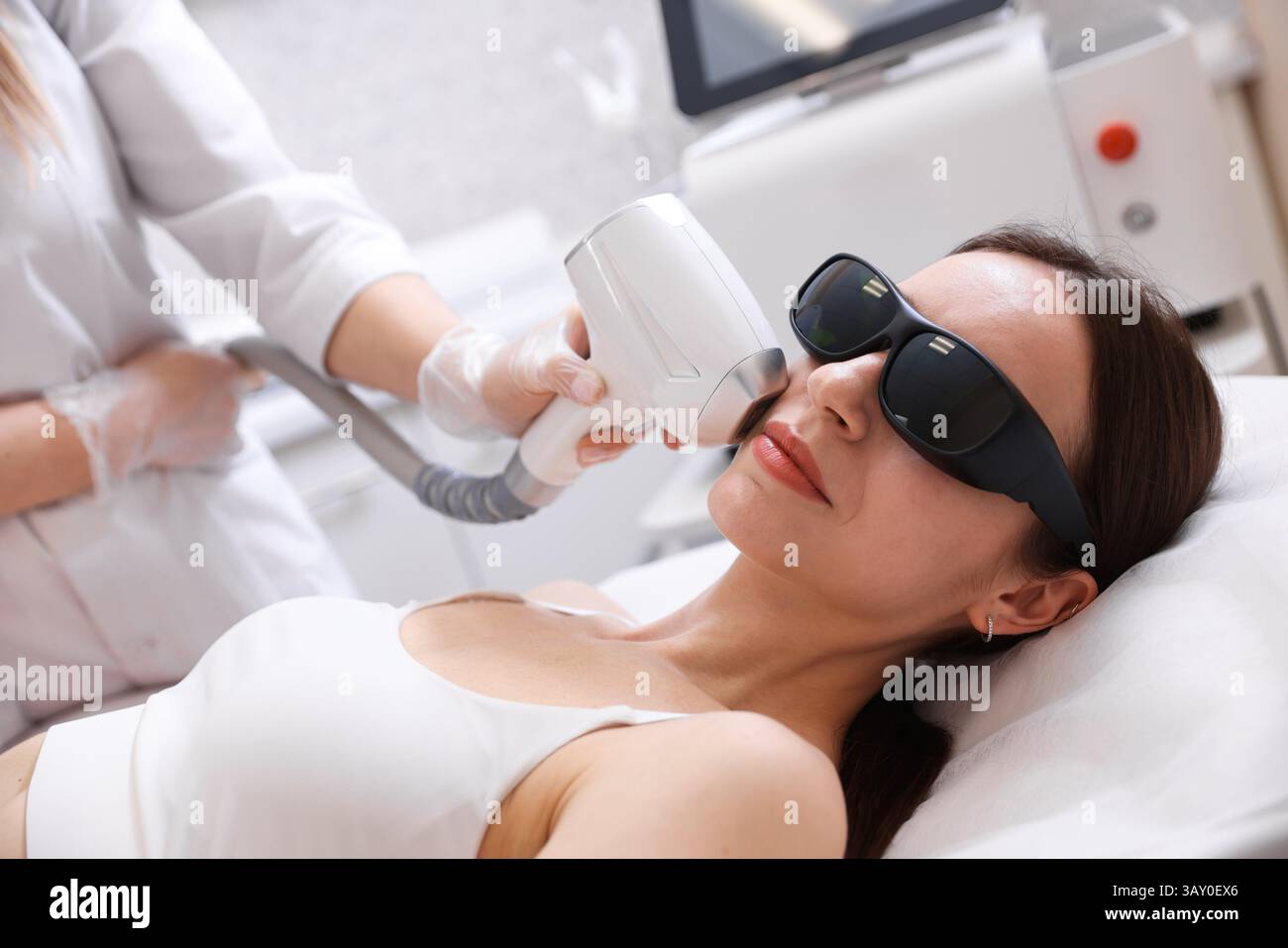 Woman during laser depilation procedure in beauty salon Stock Photo - Alamy