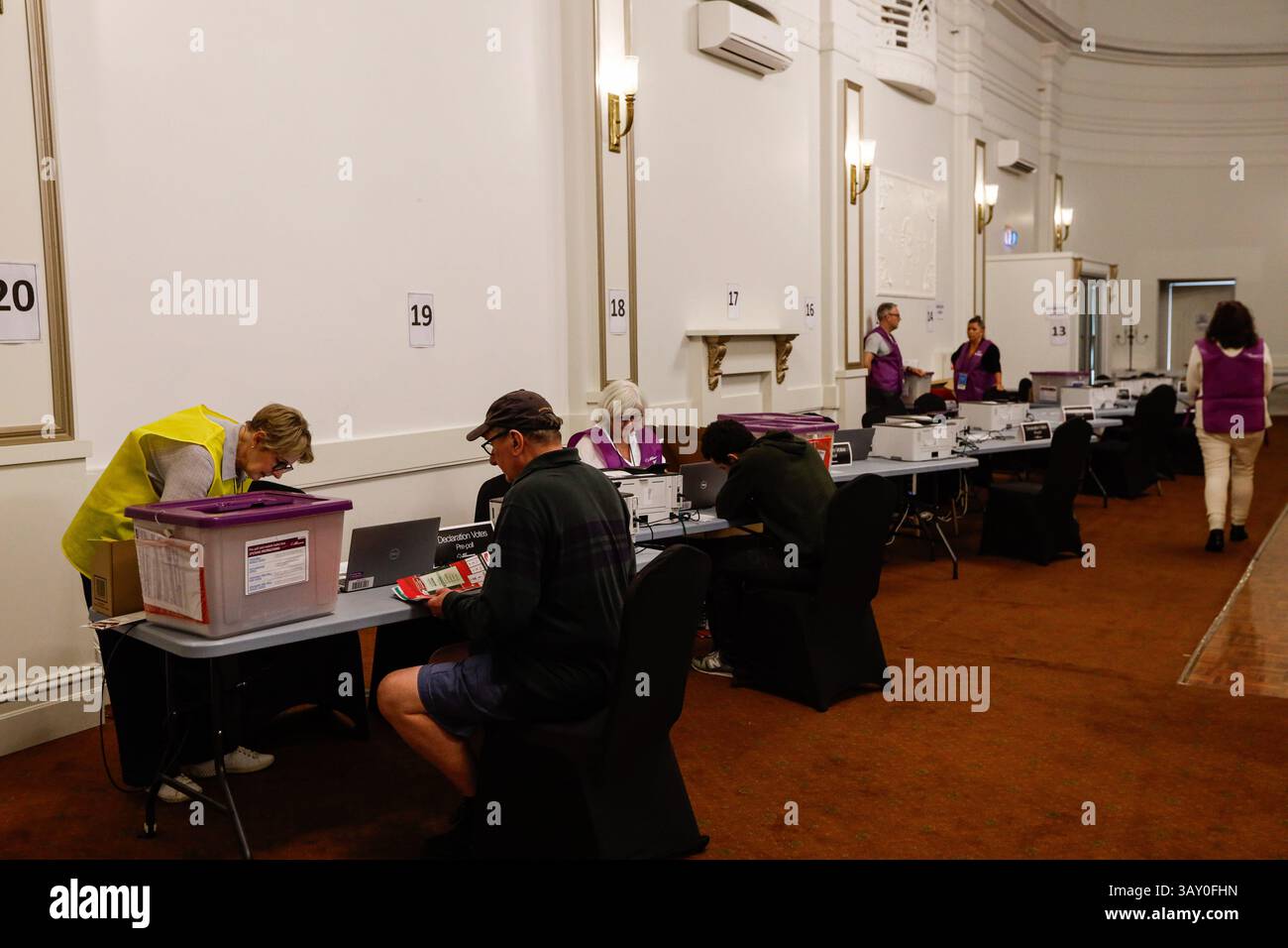 Voters make a declaration vote at a pre-poll centre with assistance ...