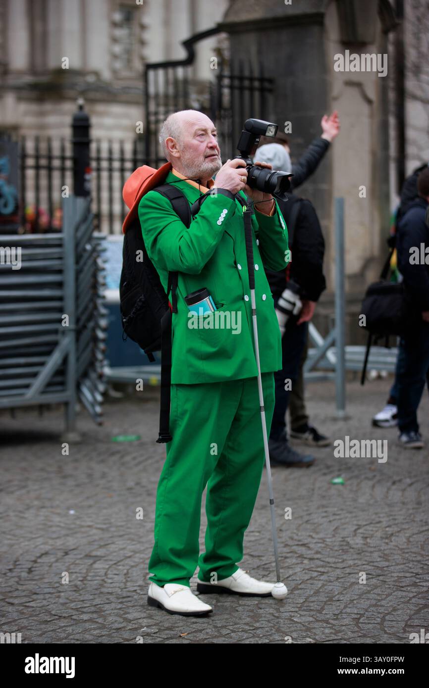 Aidan Murray, partially sighted photographer, taking photos during St ...