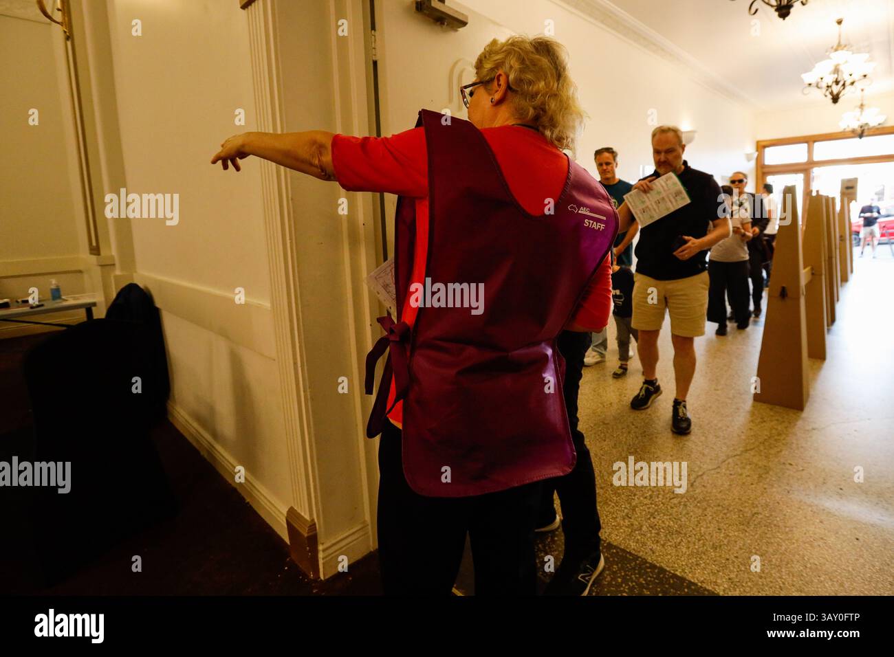 AEC staff assist voters at a polling centre during the early voting for ...
