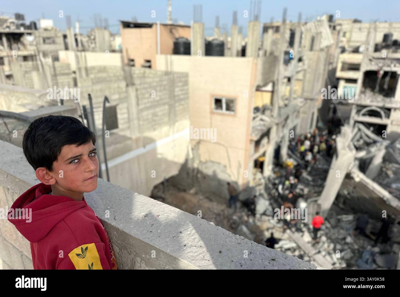 Palestinians inspect the area among the rubbles of destroyed buildings ...