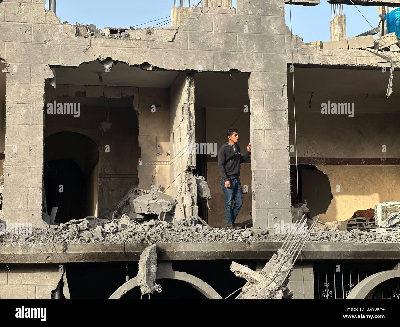 Palestinians inspect the area among the rubbles of destroyed buildings ...