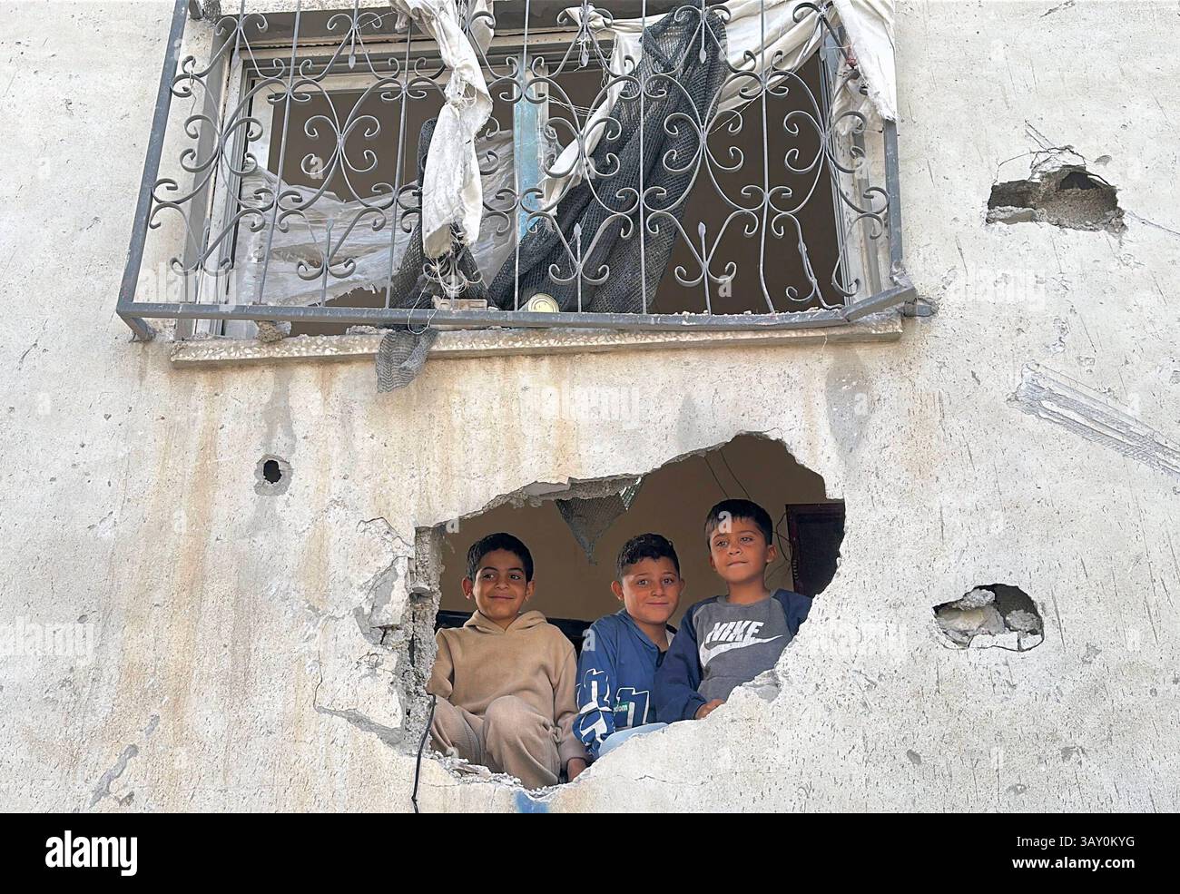 Palestinians inspect the area among the rubbles of destroyed buildings ...