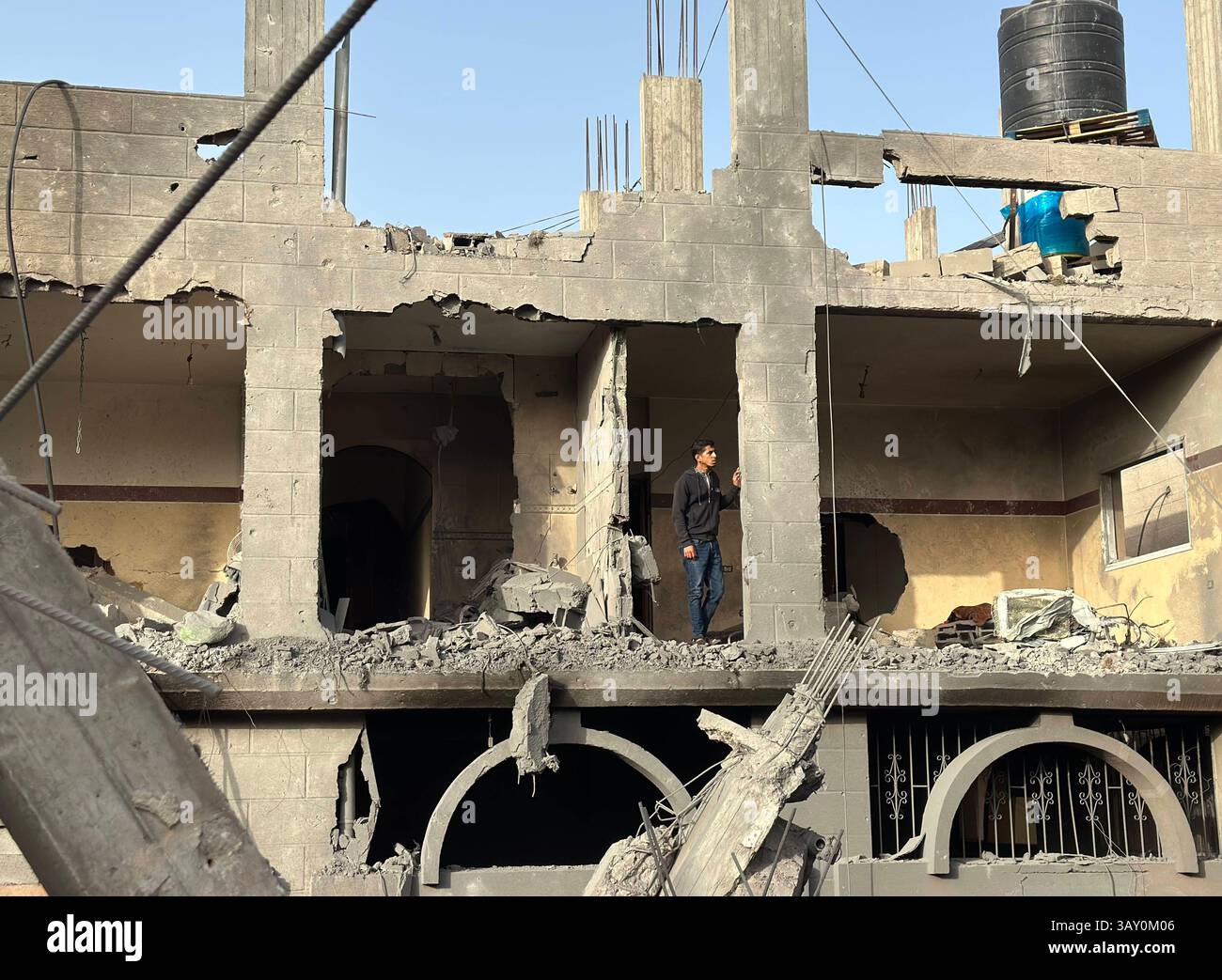 Palestinians inspect the area among the rubbles of destroyed buildings ...