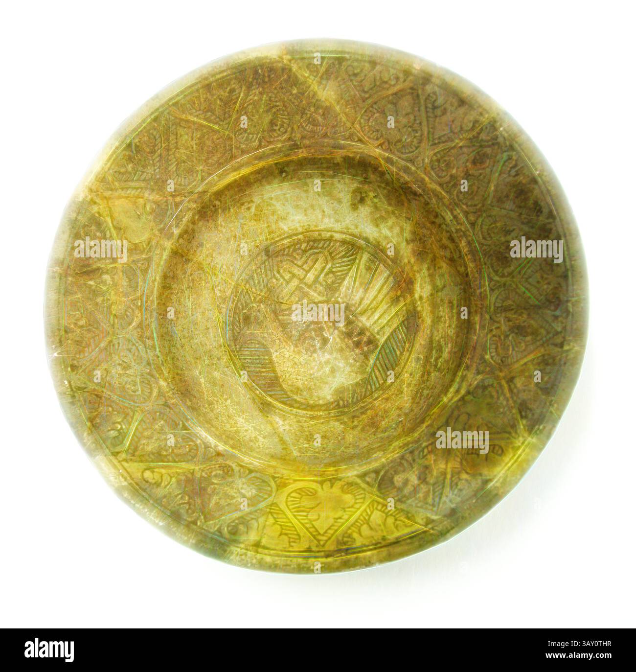An intricately designed round plate featuring delicate patterns and a ...
