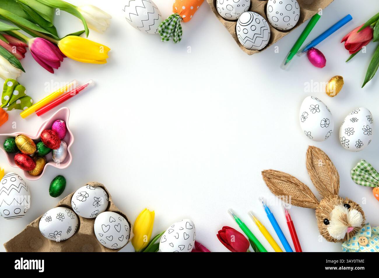 Easter flat lay with eggs for coloring, colorful tulips, felt-tip pens ...