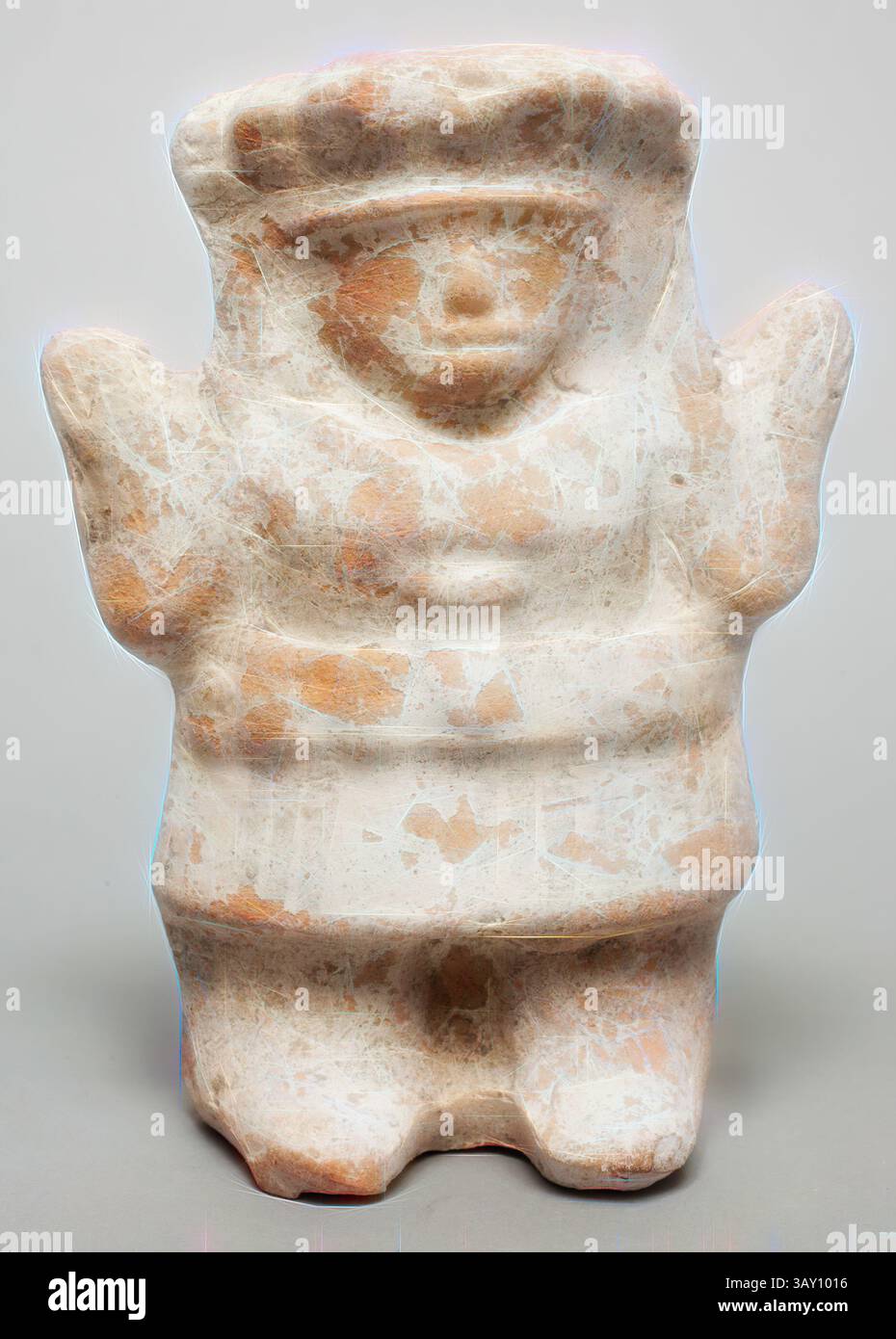 A carved stone figure depicting a humanoid with outstretched arms ...