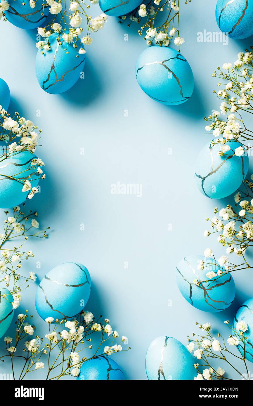 Flat lay vertical composition with marble Easter eggs and spring ...
