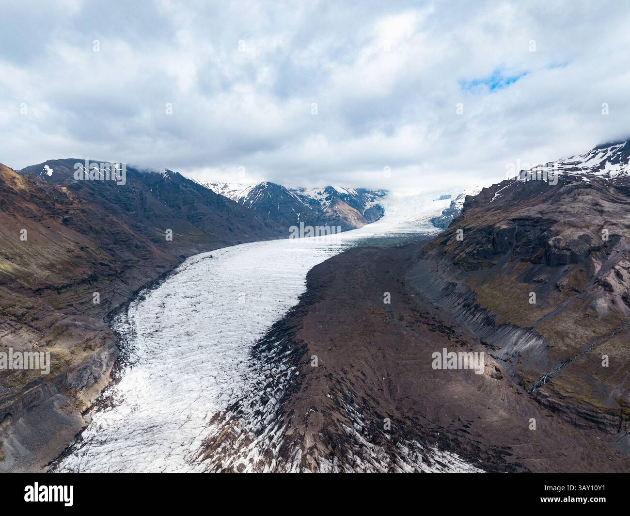 Aerial view of Vatnajökull glacier winding through rugged Icelandic ...