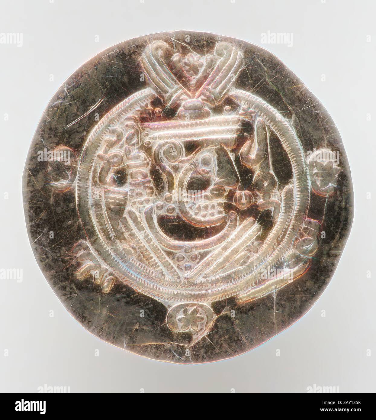 An intricate circular coin featuring detailed engravings of ...