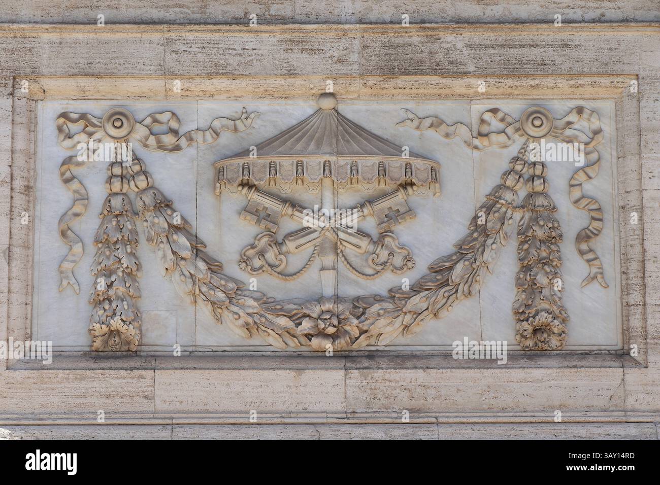 Sculpted papal keys, umbrella and a garland on the facade of the St ...