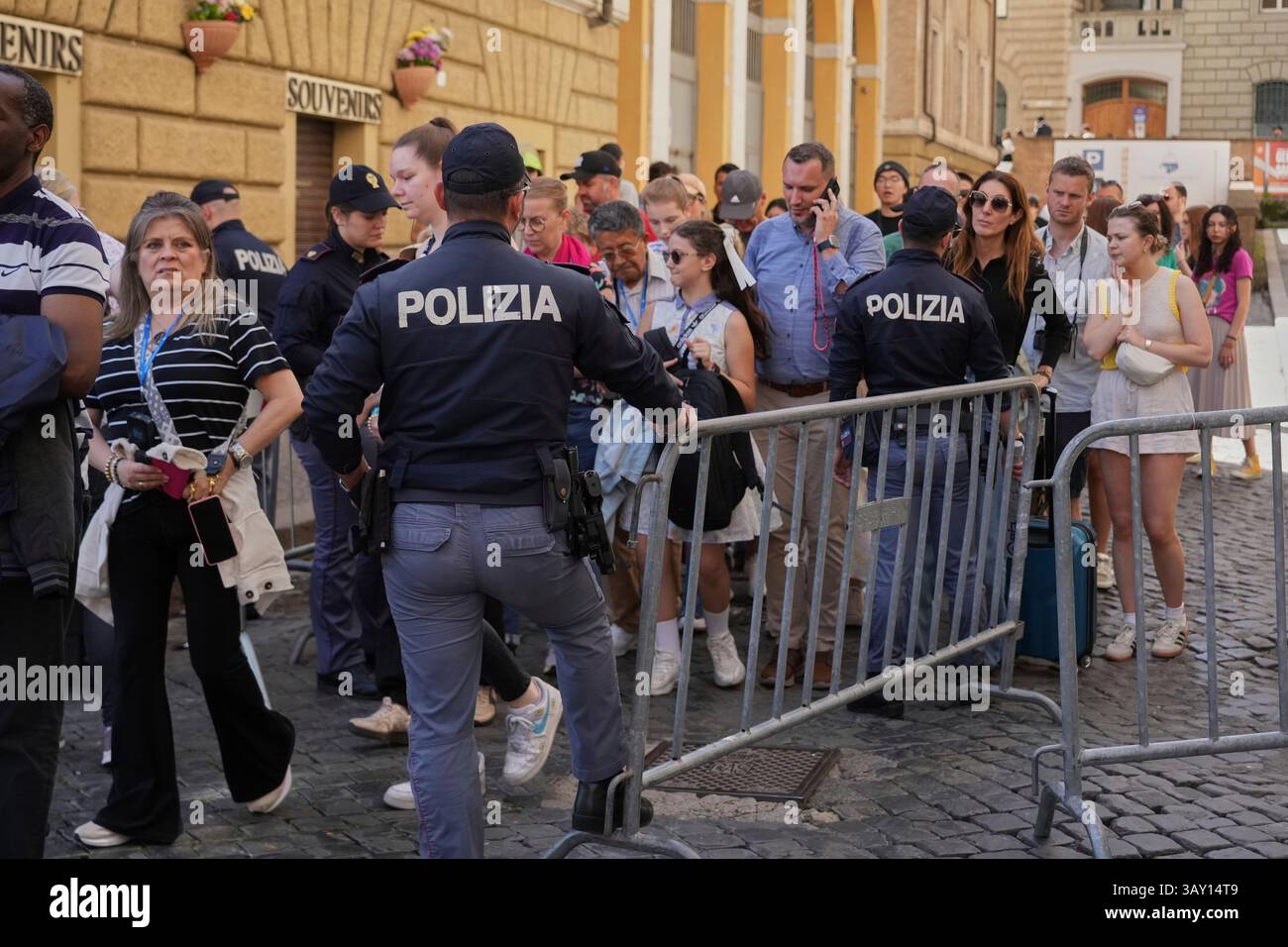 Italian police officers monitor the flow of near the Vatican, Tuesday ...