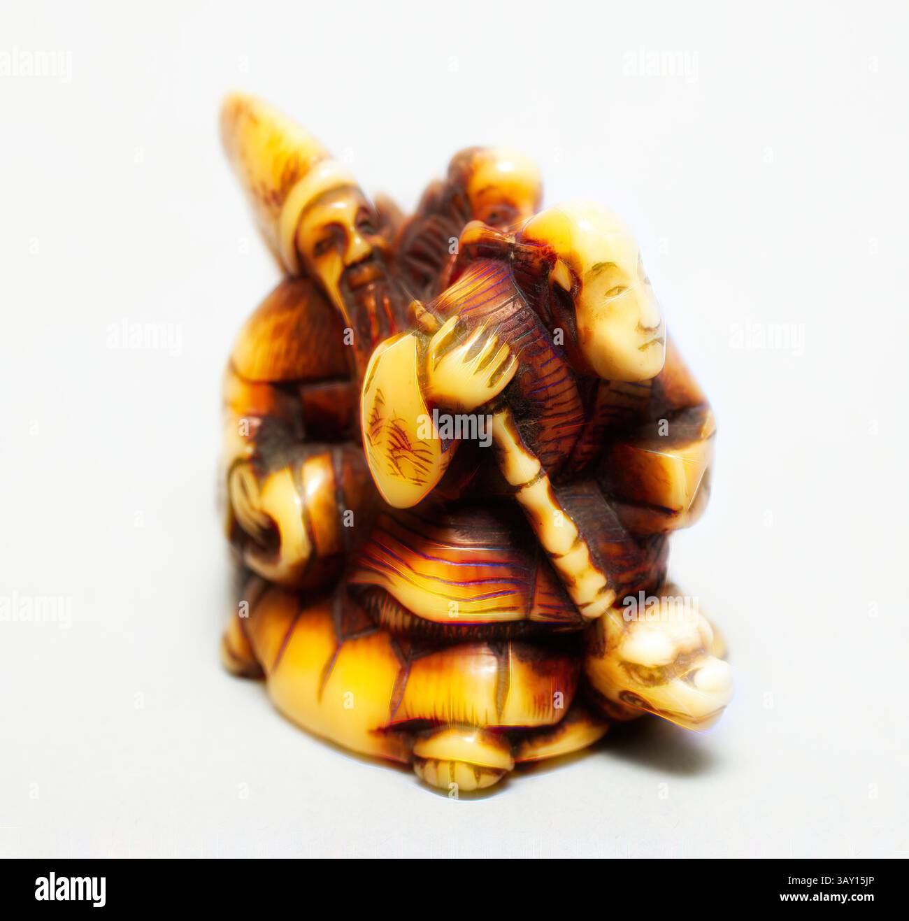 An intricately carved figure depicting three wise figures in ...