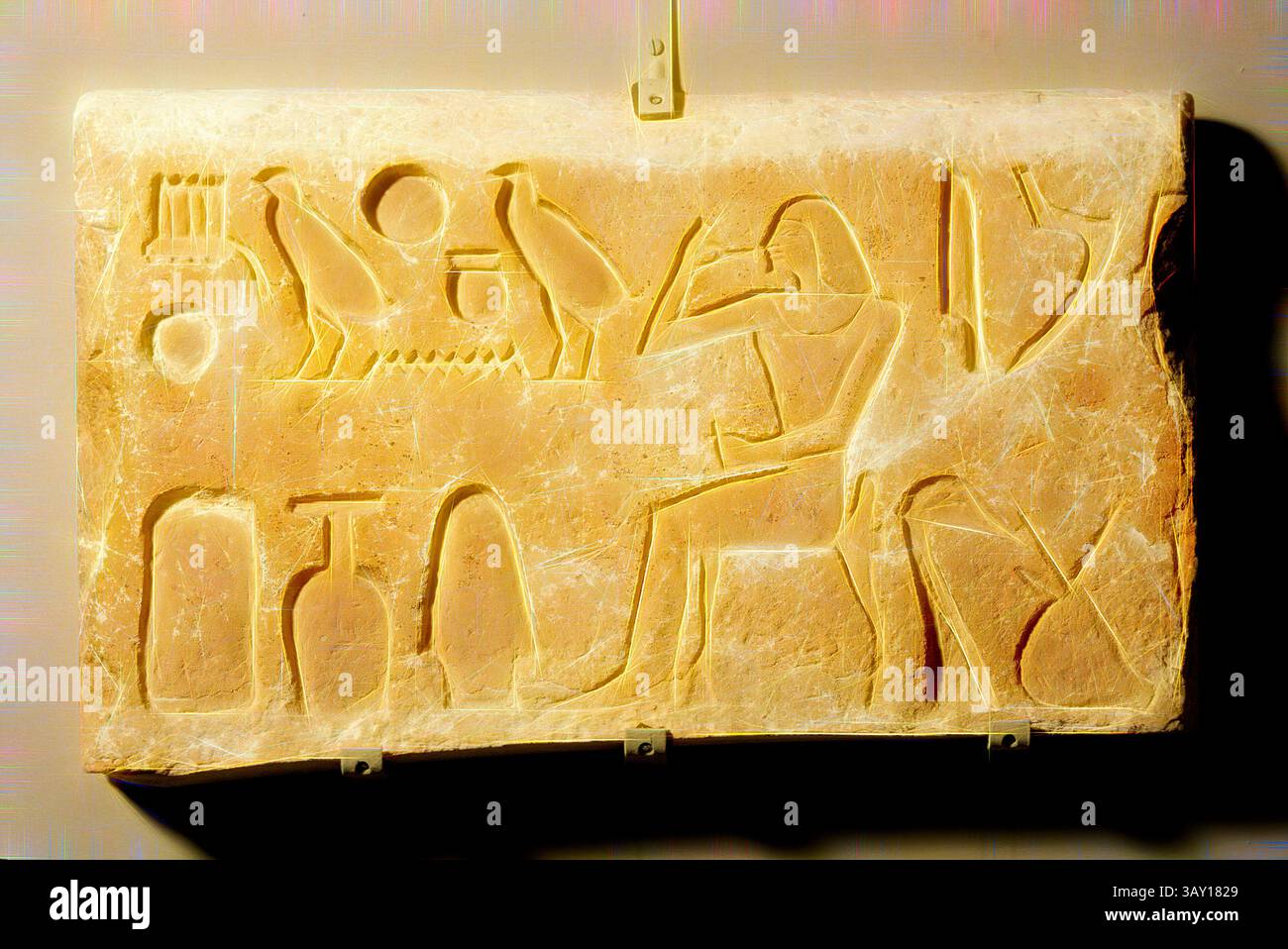 An ancient stone tablet features intricate carvings of hieroglyphs ...