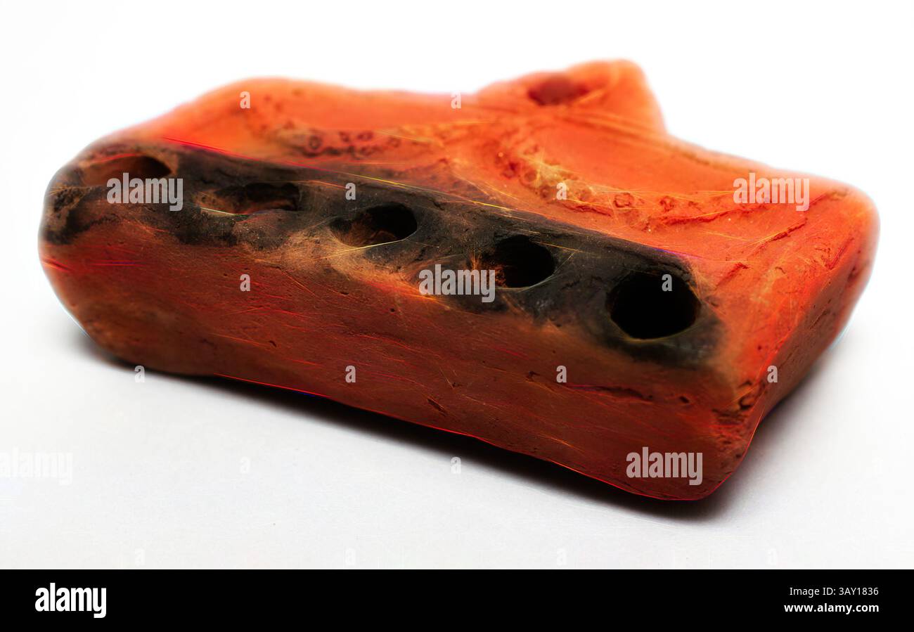 An intricately carved clay whistle featuring a unique design and ...