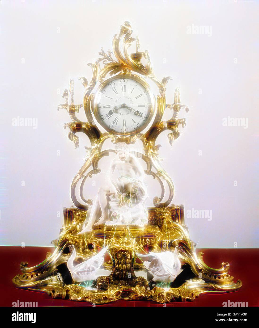 An intricately designed ornate clock features delicate figurines and ...