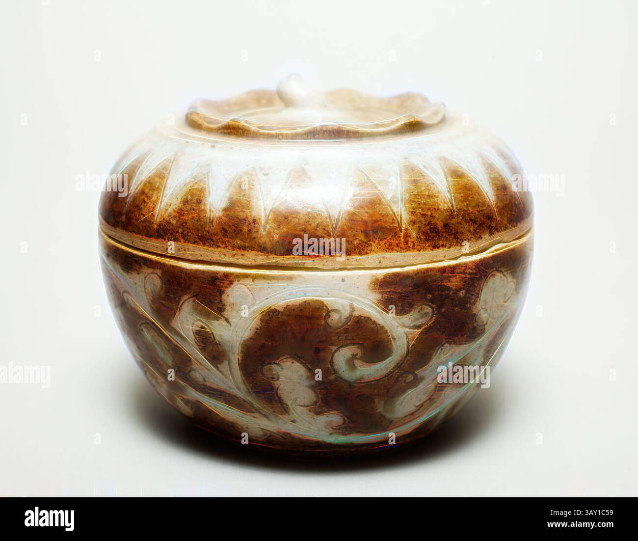A beautifully crafted ceramic jar adorned with intricate floral ...