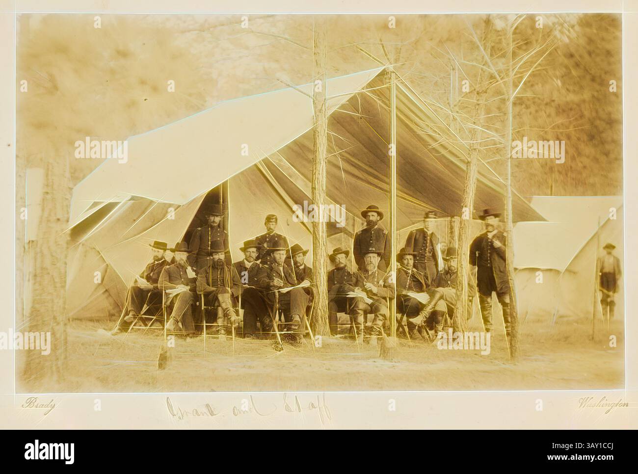A group of military officers poses in front of a large canvas tent ...