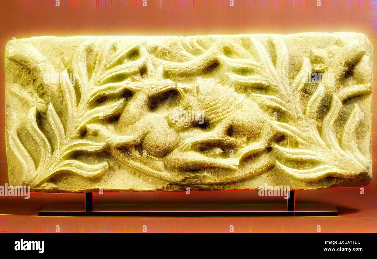 An intricately carved stone relief features detailed depictions of two ...