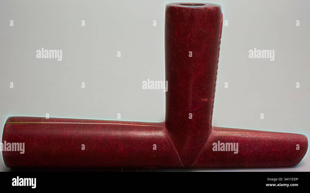 A uniquely shaped red object with a cylindrical body featuring an ...